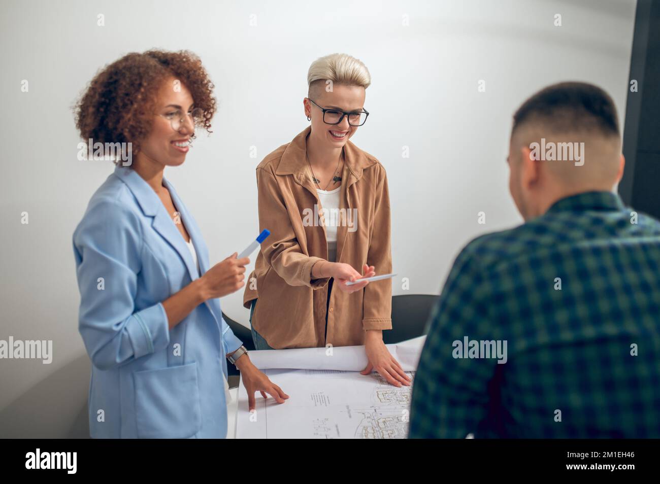 Architectural team involved in the discussion of a technical drawing ...