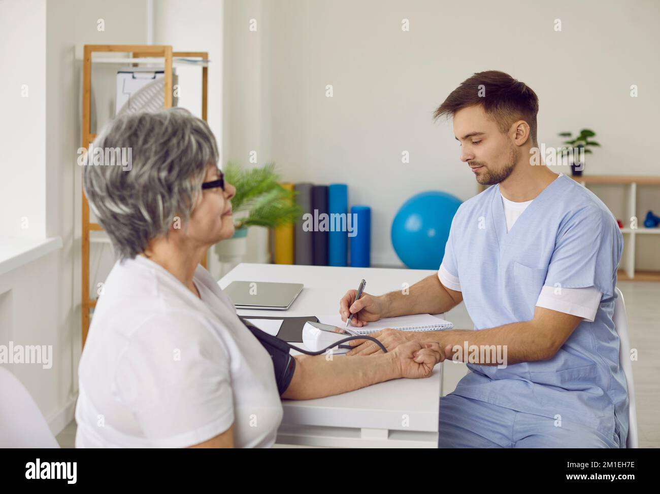Elderly physician using tonometer hi-res stock photography and images ...