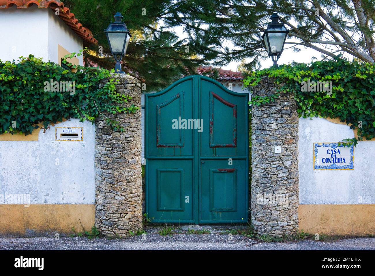 Green entrance gate idyllic entrance Stock Photo - Alamy