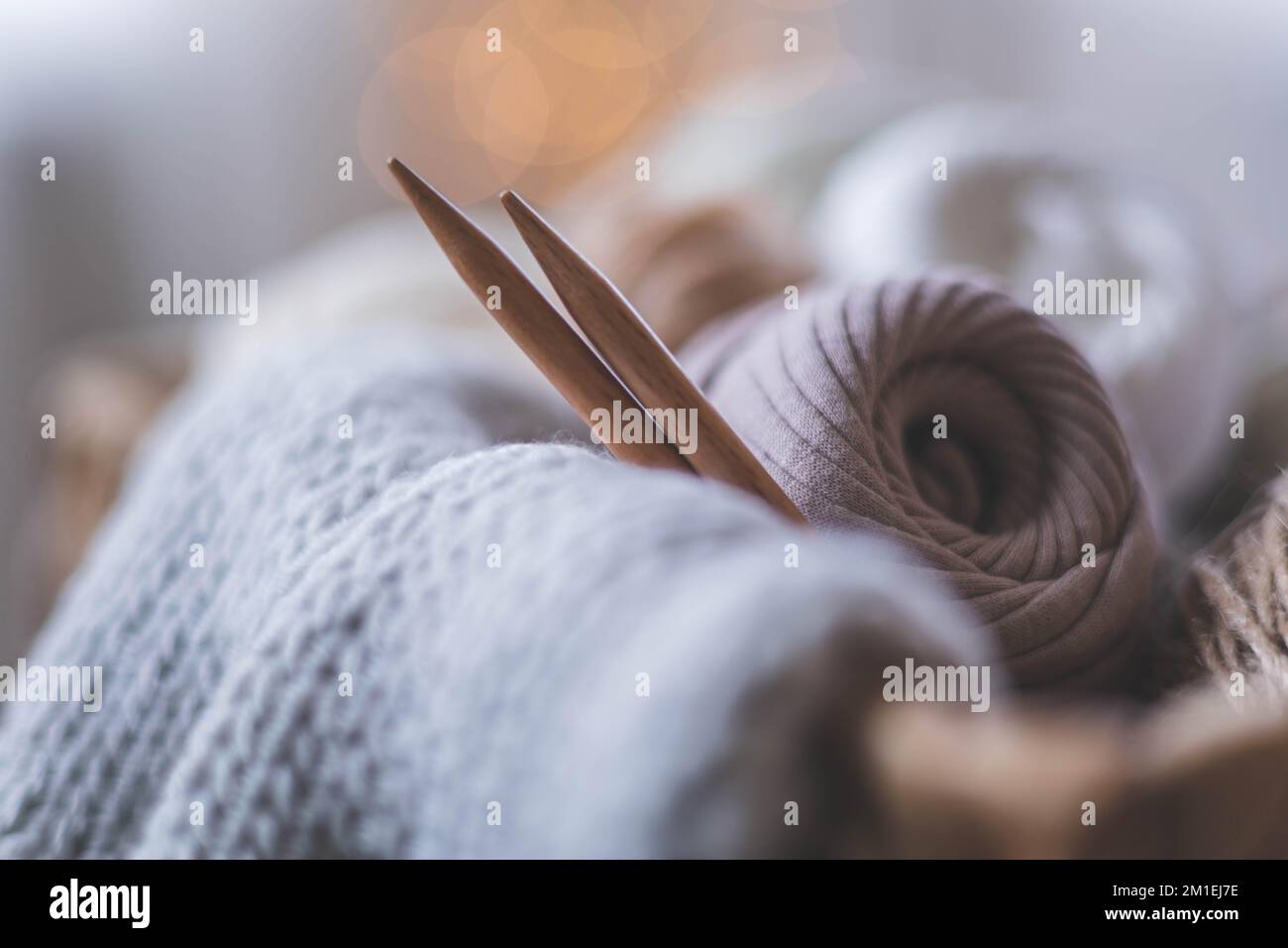 Cozy homely atmosphere. Female hobby knitting. Yarn in neutral shades ...