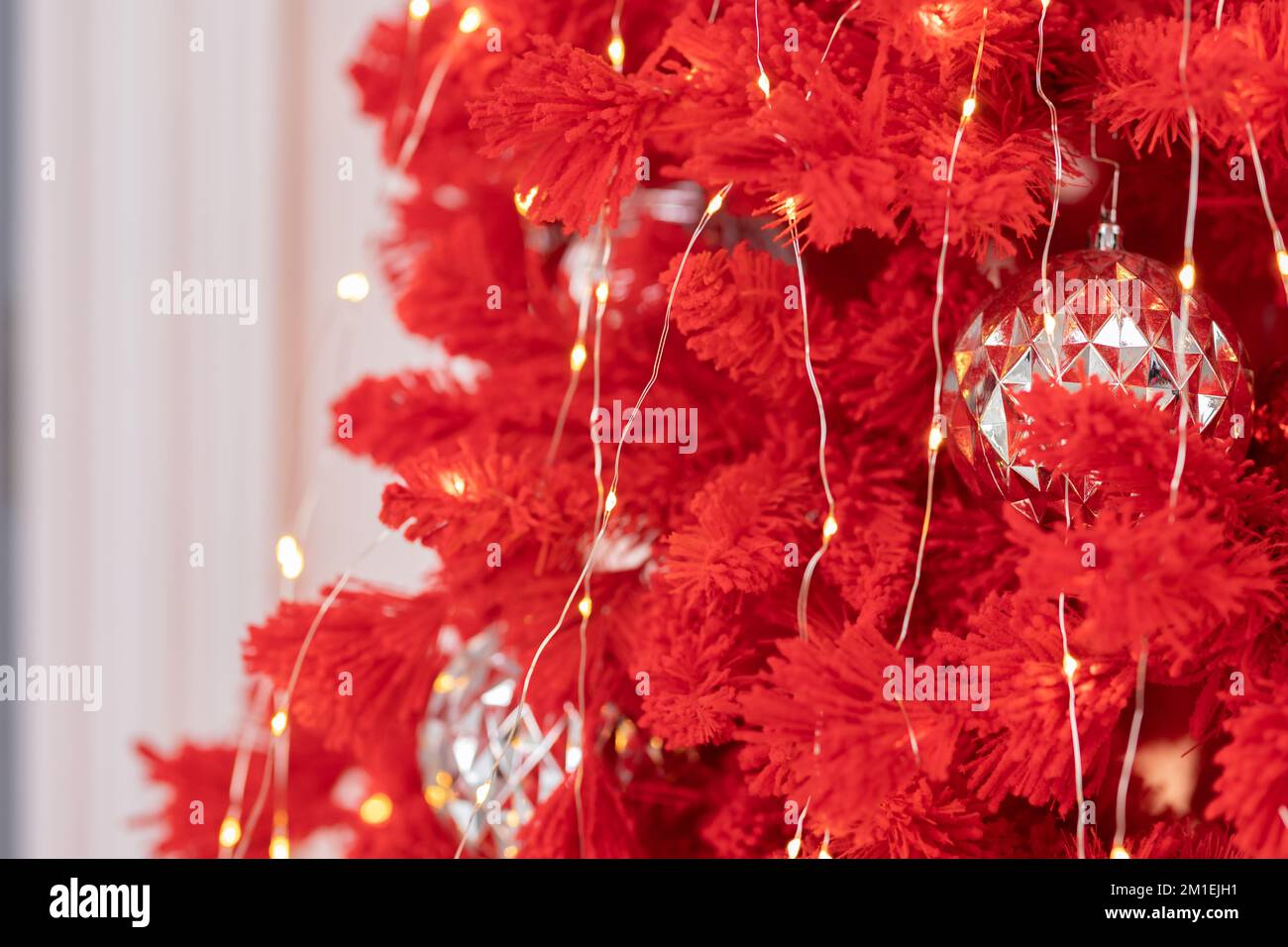 Christmas decorations on the red holiday tree. balls garland glowing ...