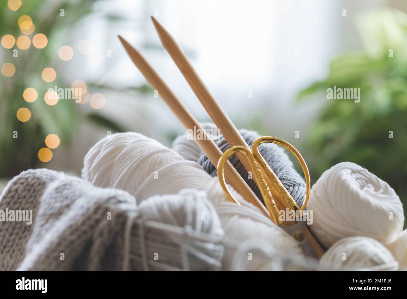 Cozy homely atmosphere. Female hobby knitting. Yarn in neutral colors ...