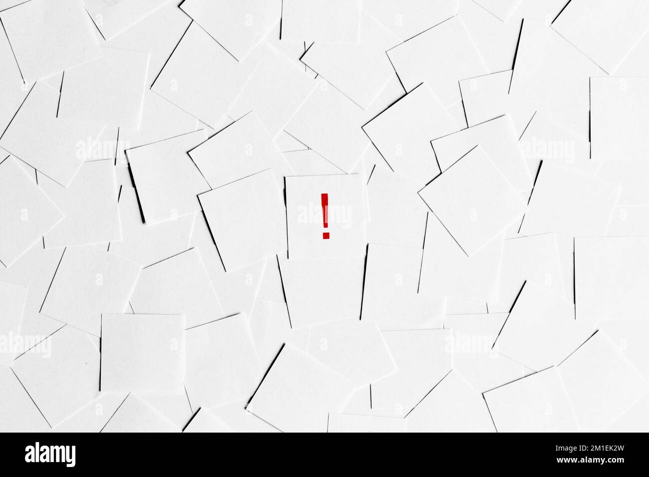 Pile of blank pieces of paper with red exclamation mark in the middle ...