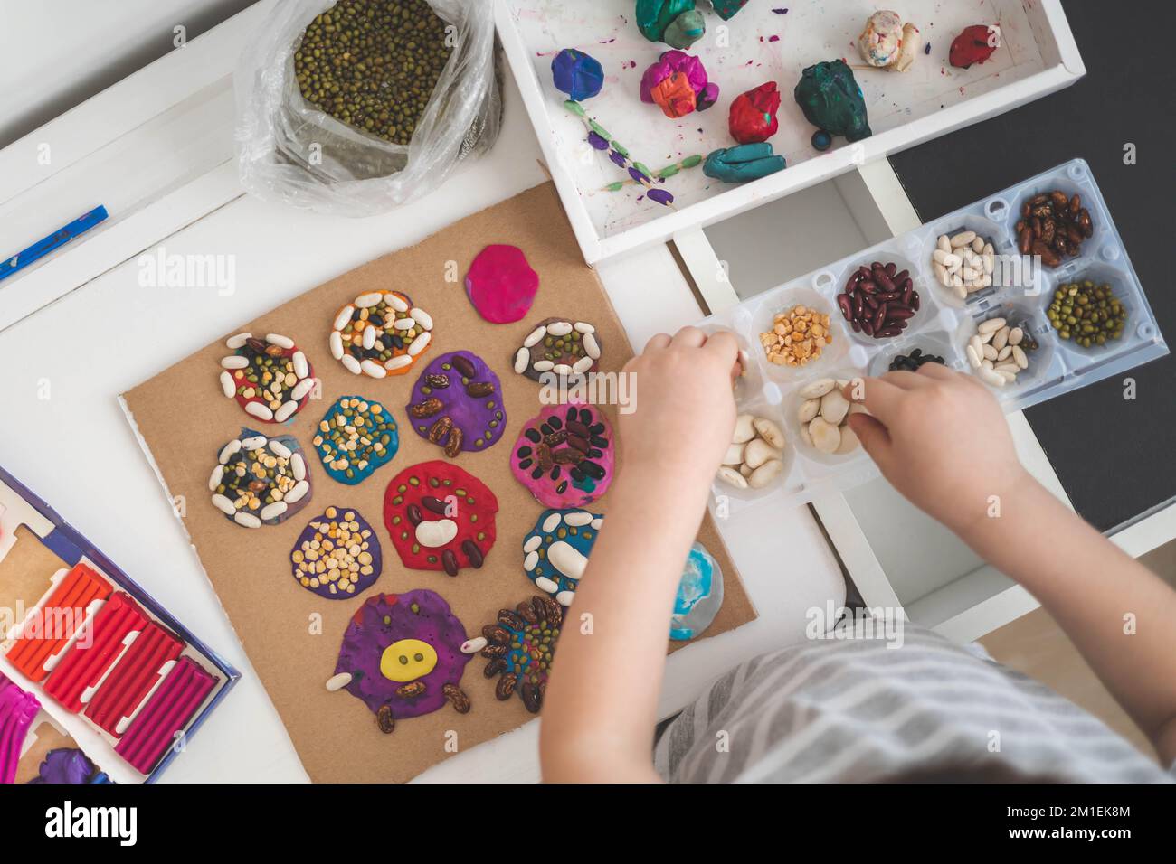 Childish hands decorated plasticine shape natural beans seeds ...