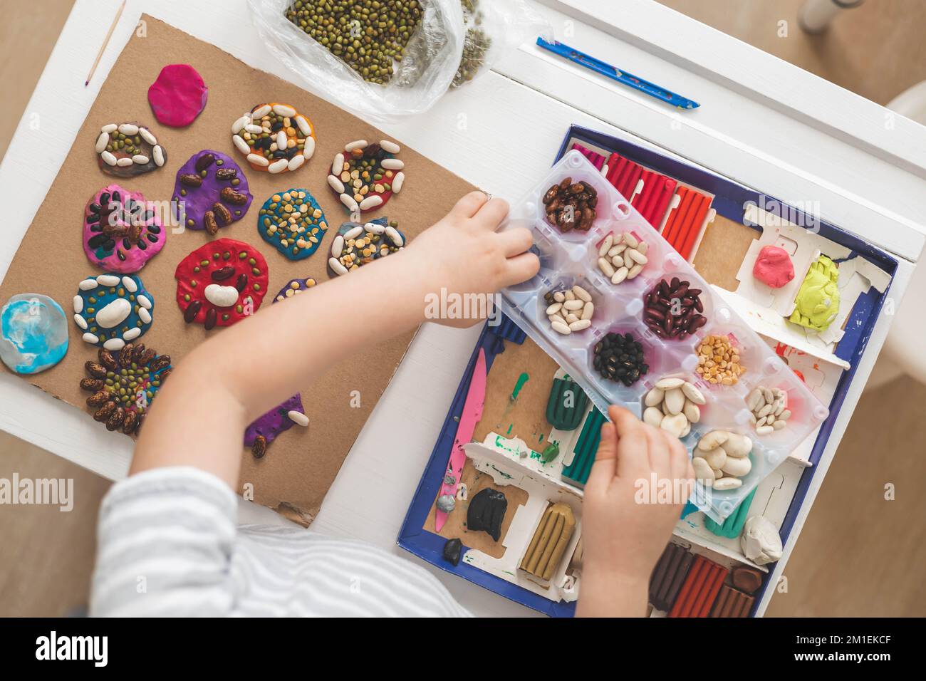 Childish hands decorated plasticine shape natural beans seeds ...