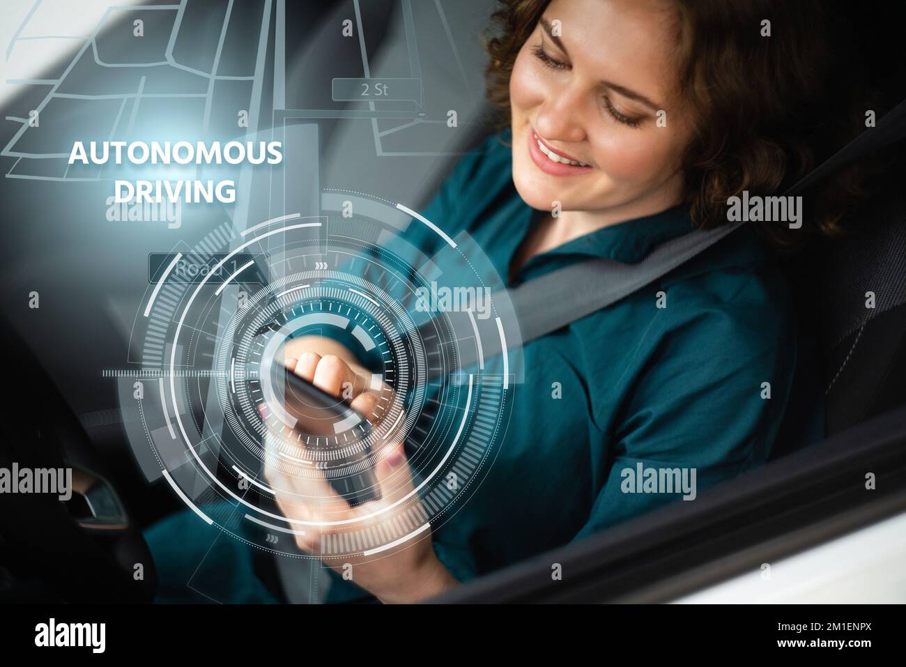 Woman driver controls an autonomous car using a smartphone Stock Photo ...
