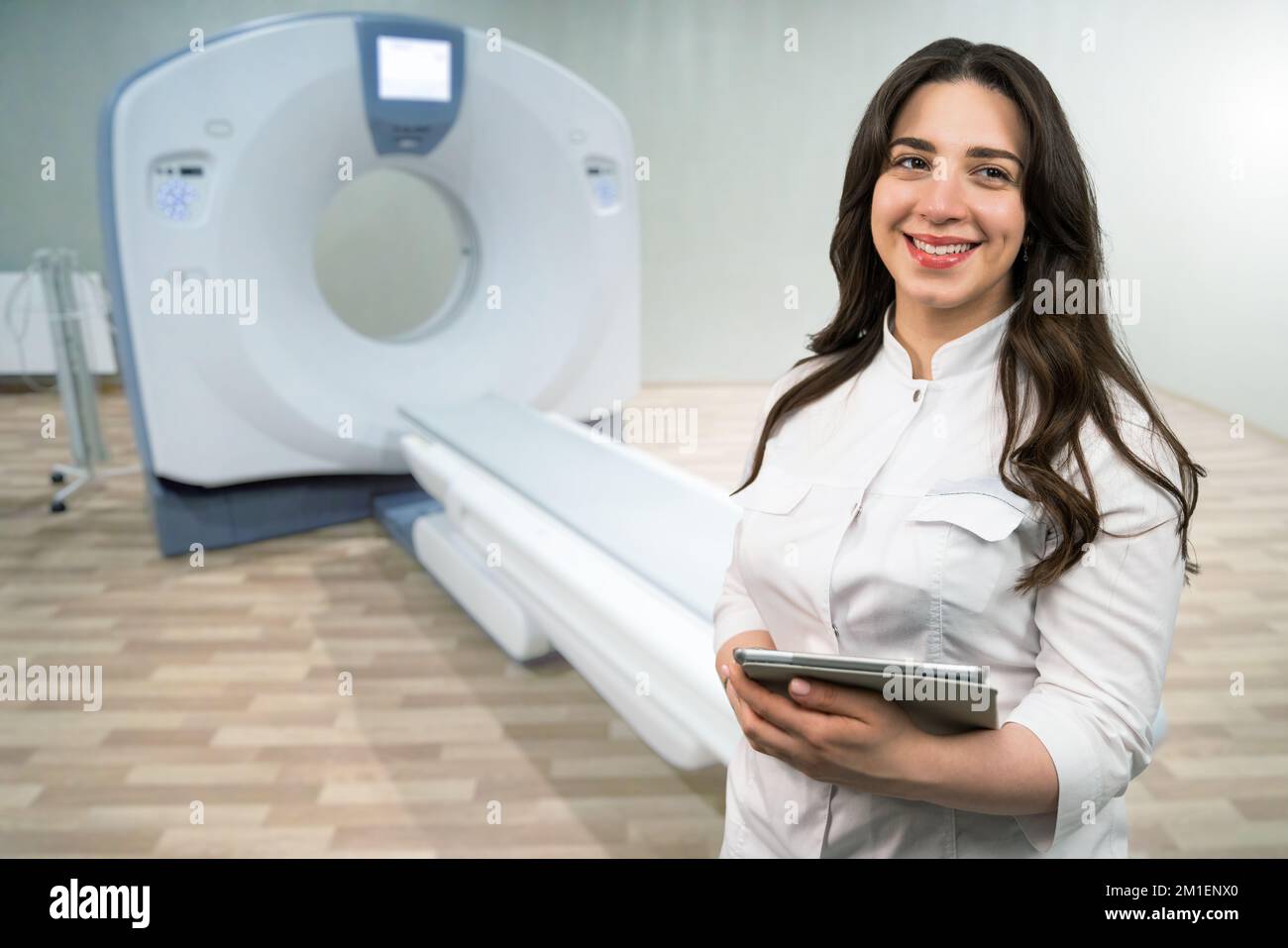Doctor with a digital tablet smiling and looking at the camera on the ...