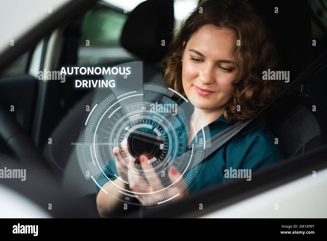 Woman driver controls an autonomous car using a smartphone Stock Photo ...