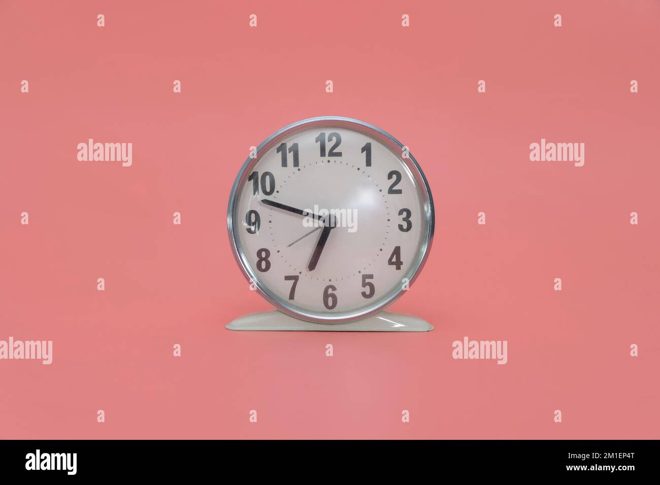 White retro alarm clock without external bell. isolated on pink ...