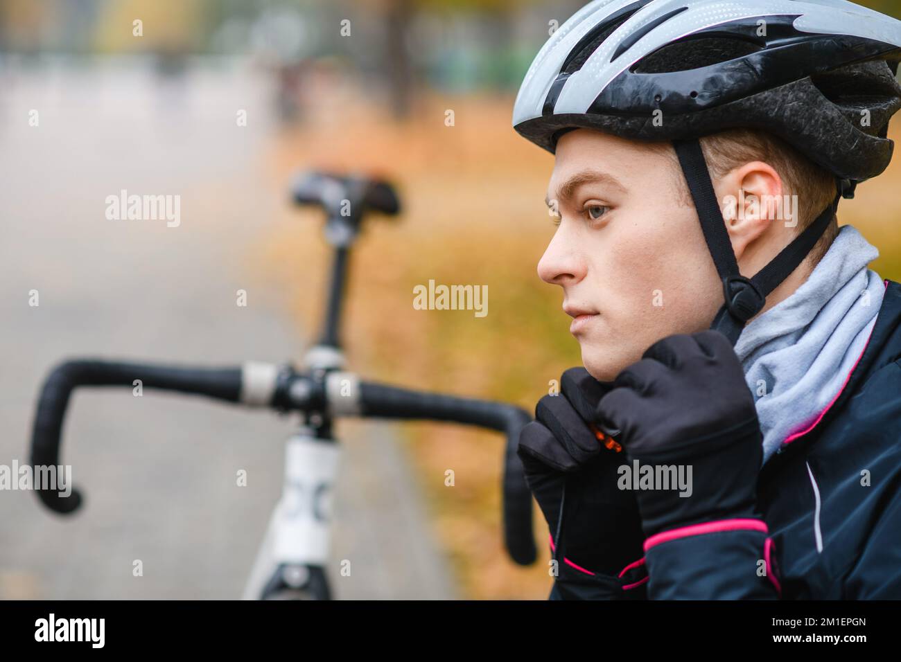 Profile of young bicyclist wear helmet outdoors Stock Photo - Alamy