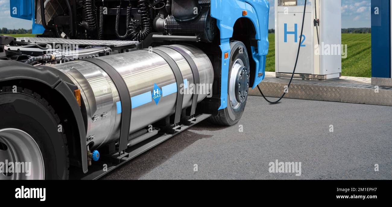 A hydrogen fuel cell semi truck with H2 gas cylinder onboard next to ...