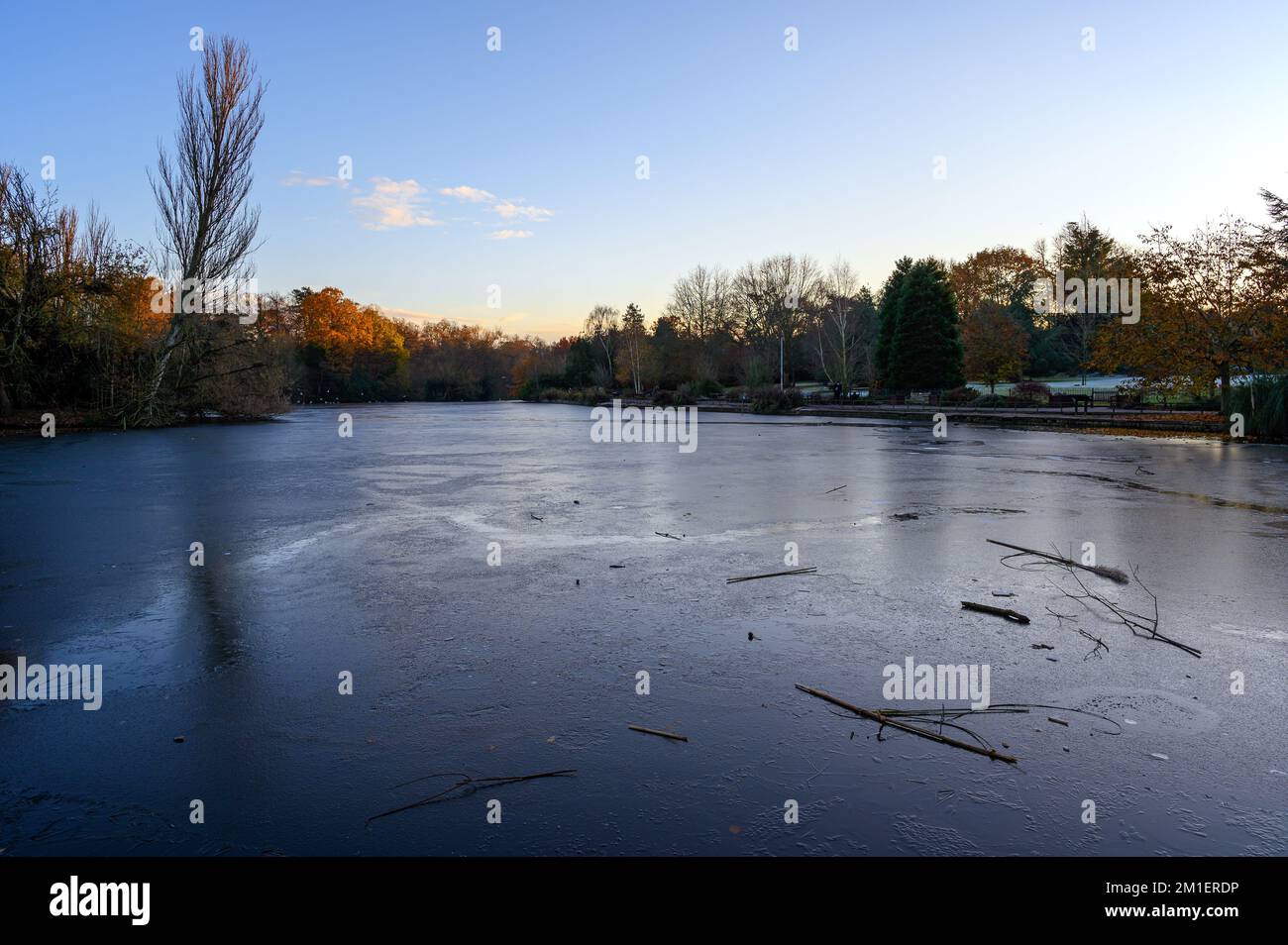 A frozen lake at sunset. There is ice on the surface of the lake in ...