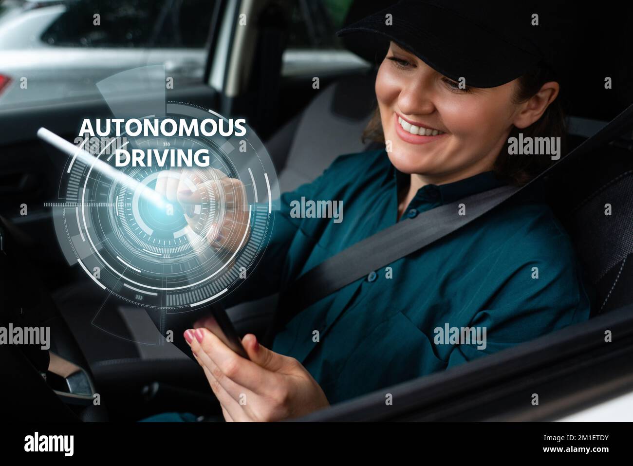 Woman driver controls an autonomous car using a smartphone Stock Photo ...