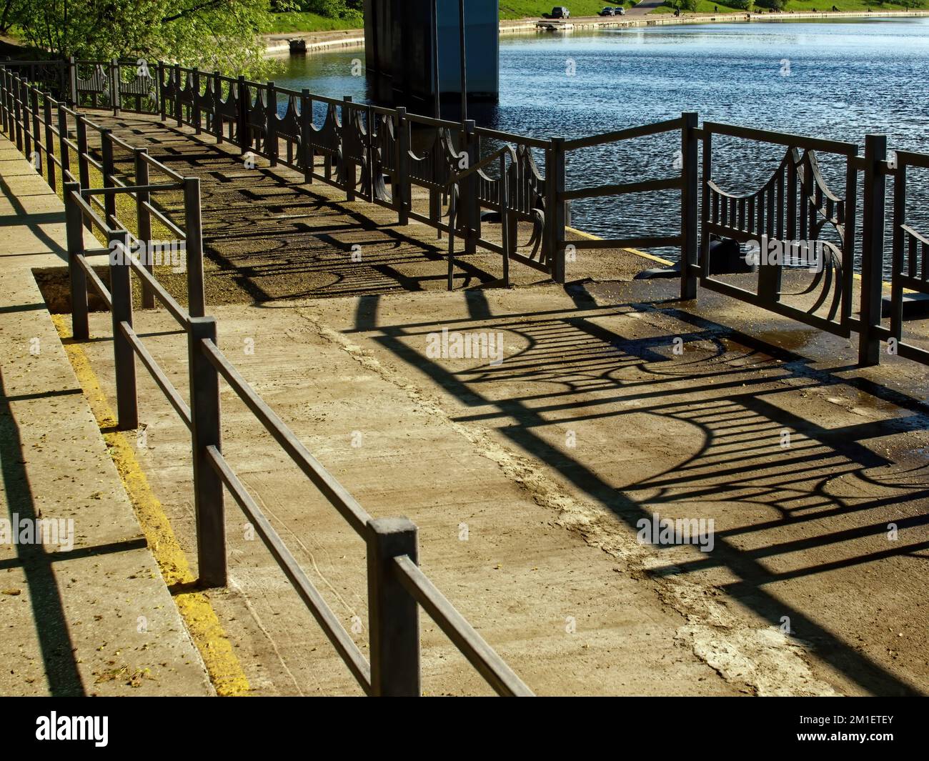 river embankment made of concrete slabs on a clear day, in summer Stock ...