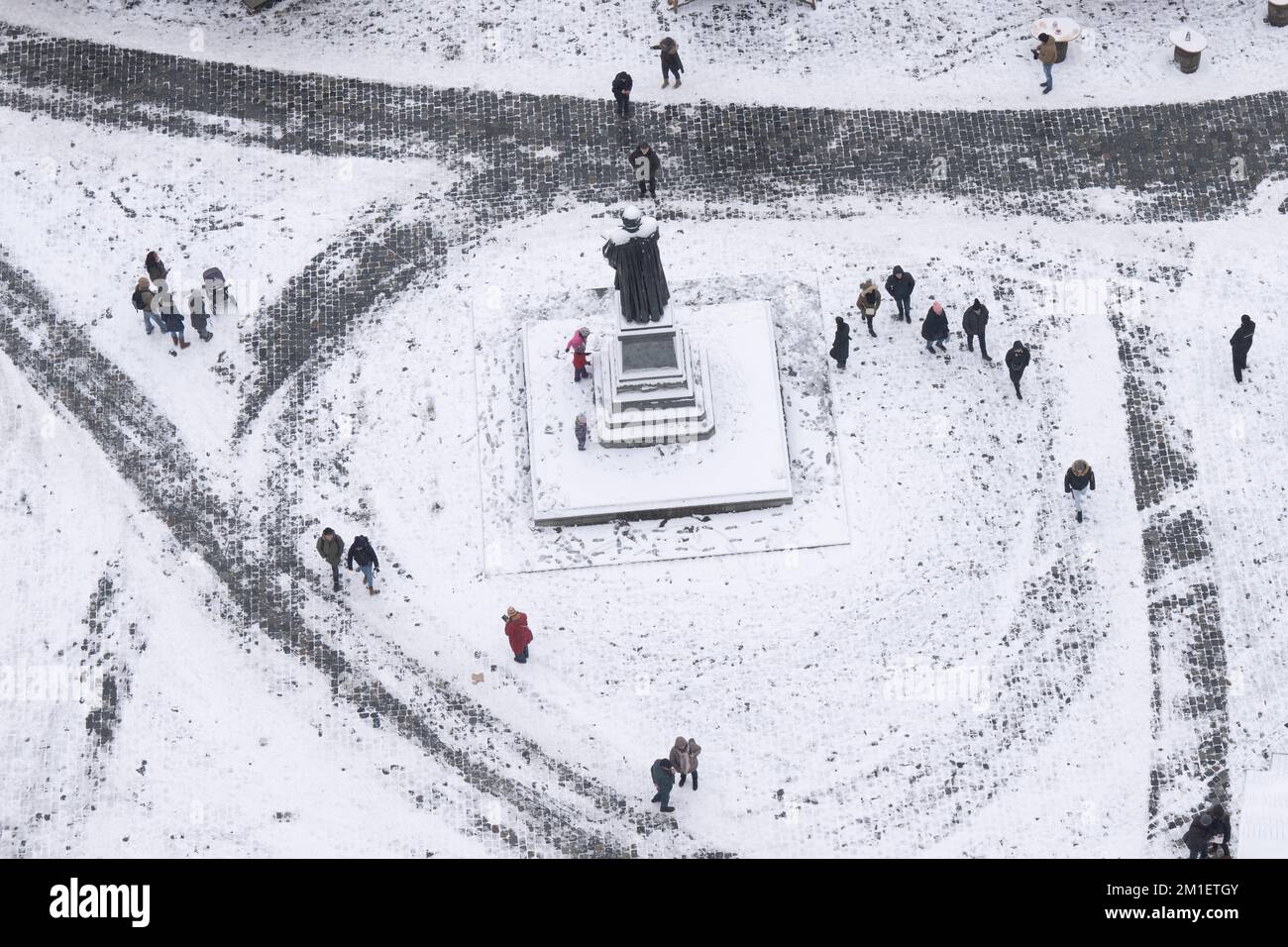 Dresden, Germany. 12th Dec, 2022. Passers-by walk through the snow on ...
