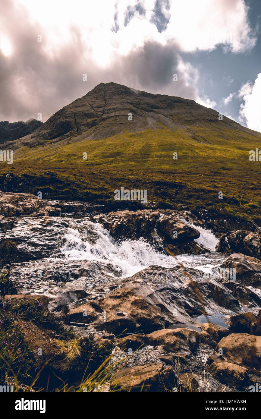 A natural view of the Fairy Pools Waterfall near a forest in Scotland ...