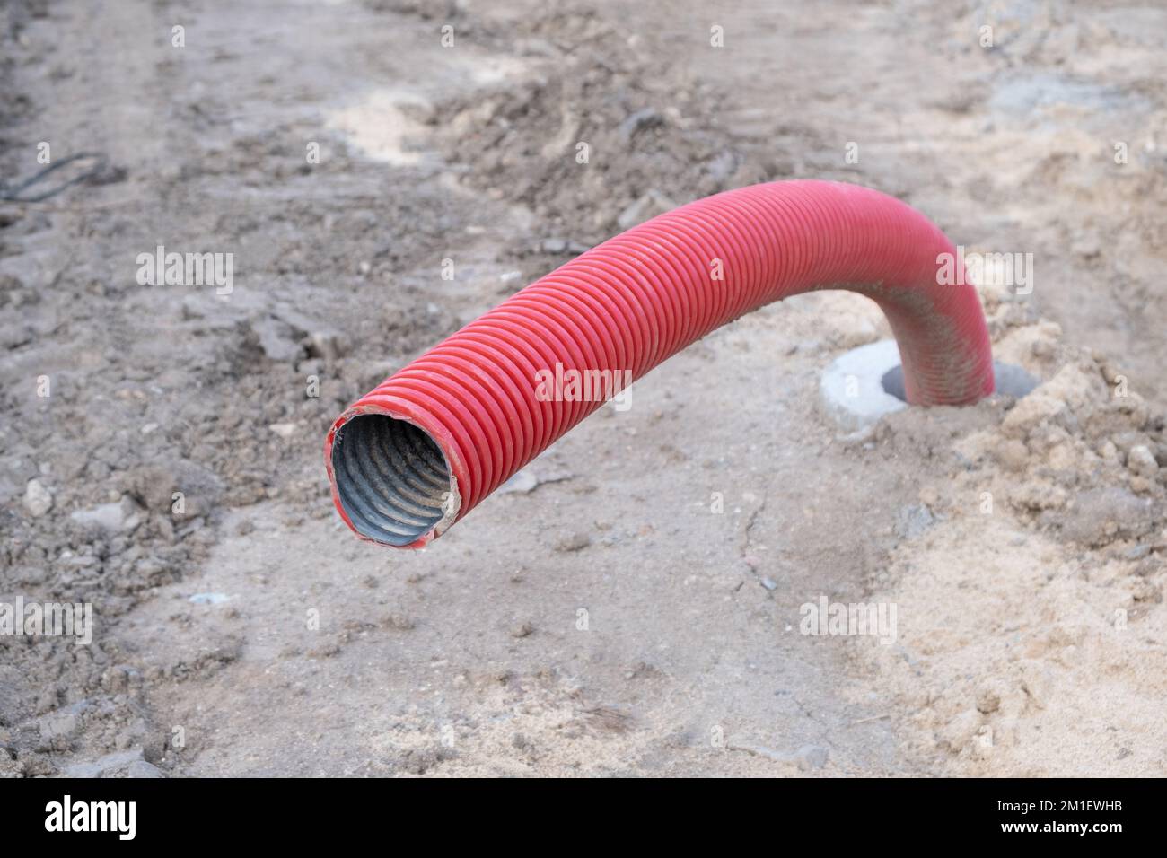 Red corrugated pipe are buried underground on Construction site Stock ...