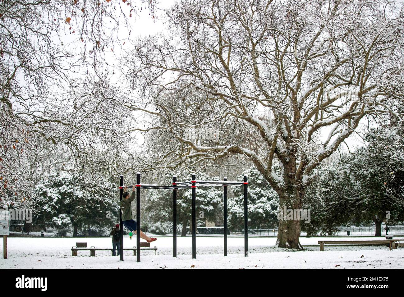 A person exercising in Kennington Park, London. Snow and ice have swept ...