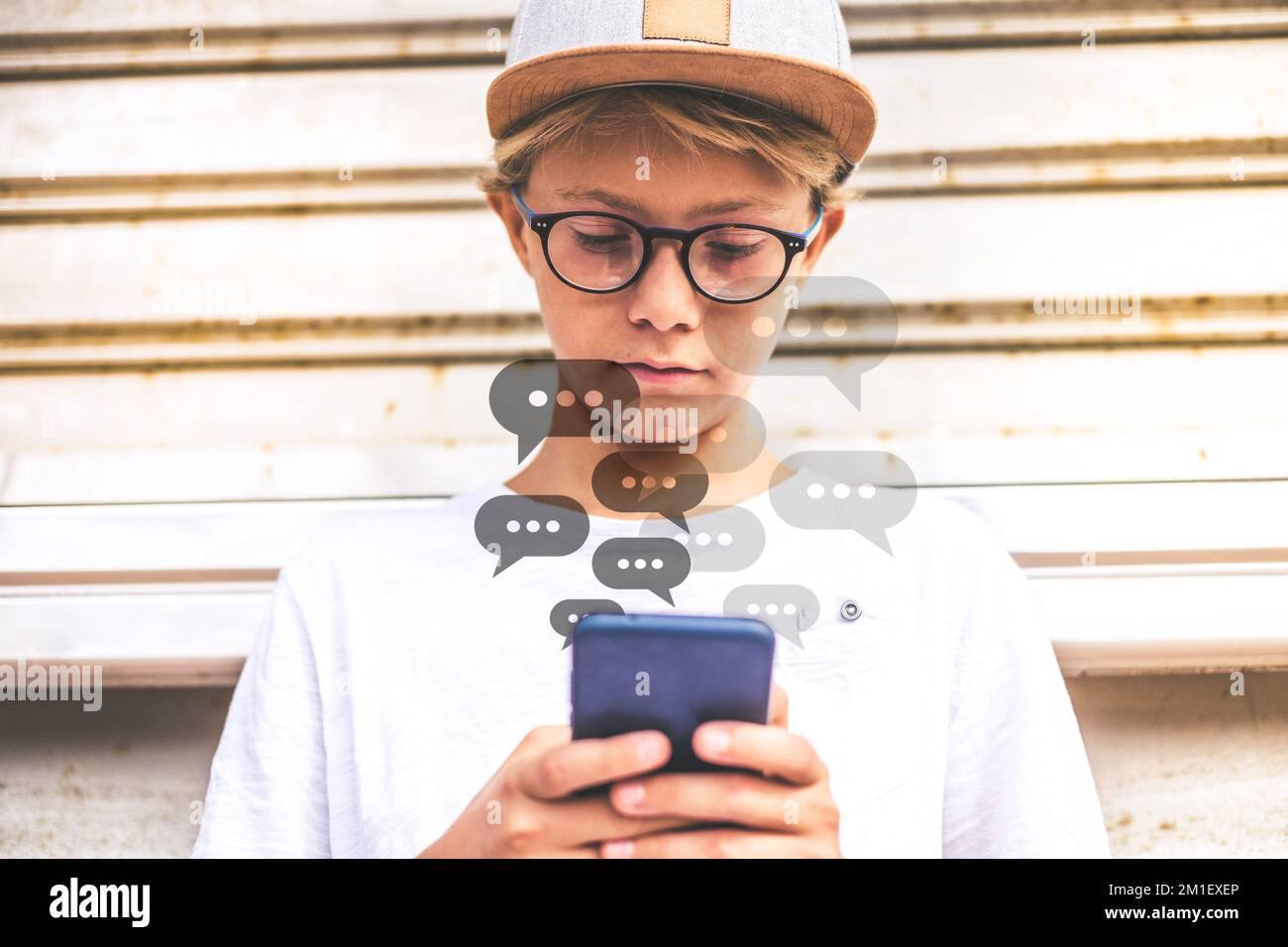 Beautiful trendy boy using smartphone in an exotic context. Image of ...