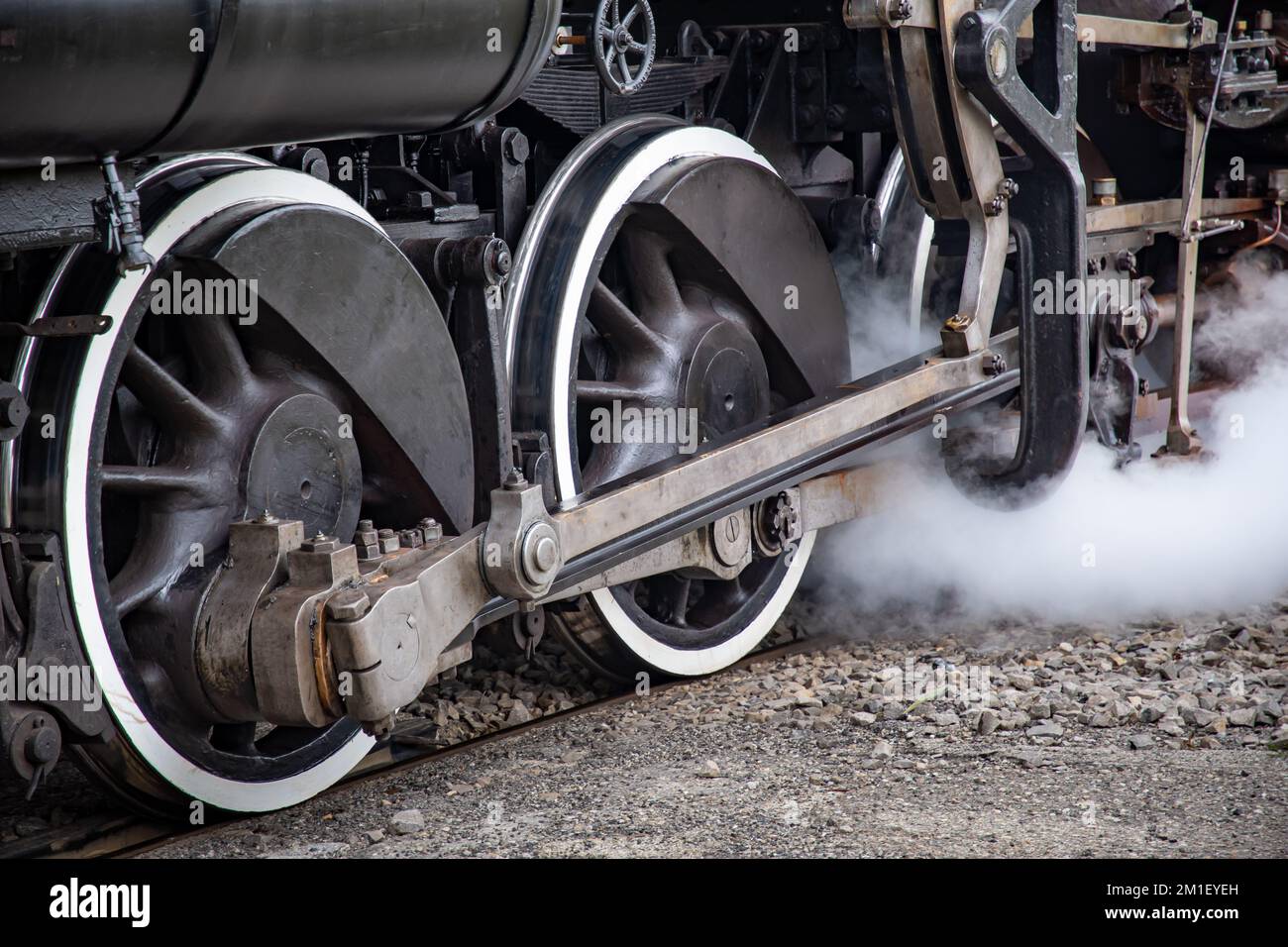 A closeup of black steam locomotive wheels on a rails Stock Photo - Alamy