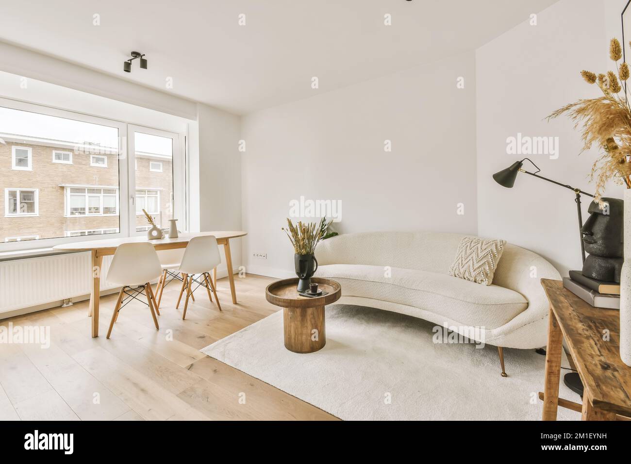 a living room with a couch, table and window looking out onto the ...