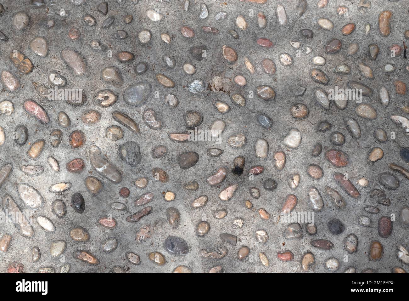 A stone wall with small pebbles Stock Photo - Alamy