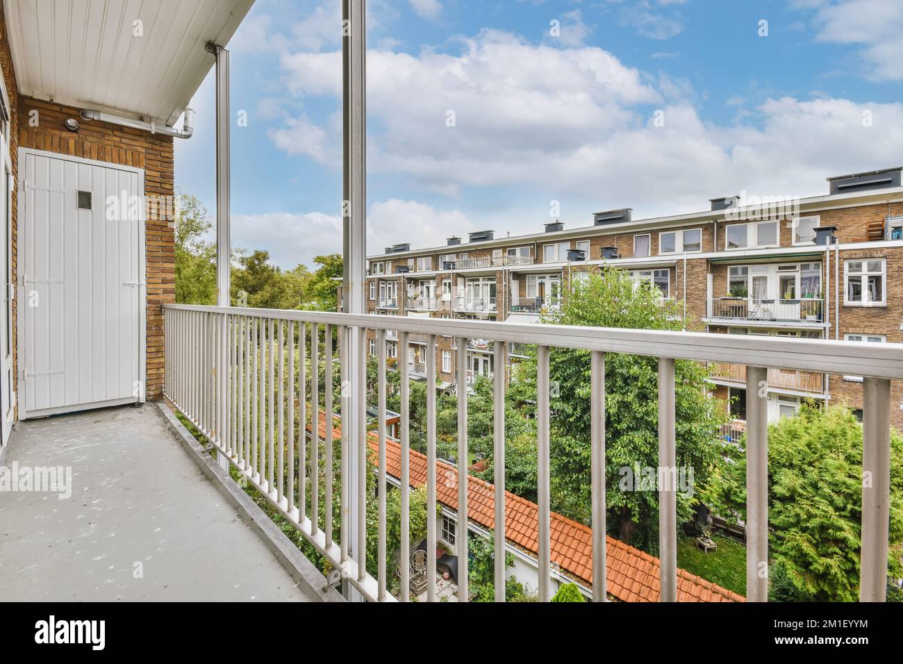 a balcony with white railings and red roof tiles on the front of an ...