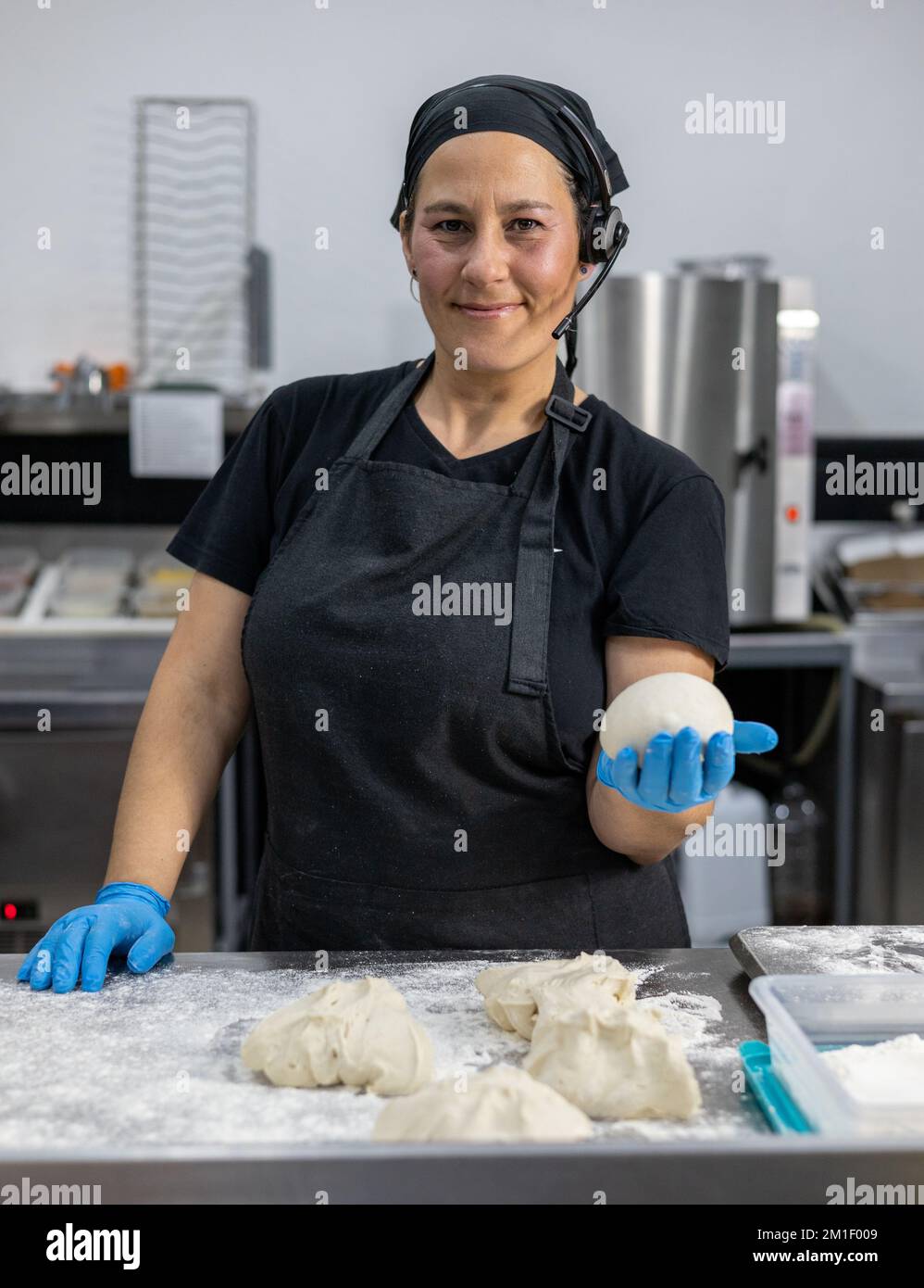 Professional Woman chef kneading bread dough Stock Photo - Alamy
