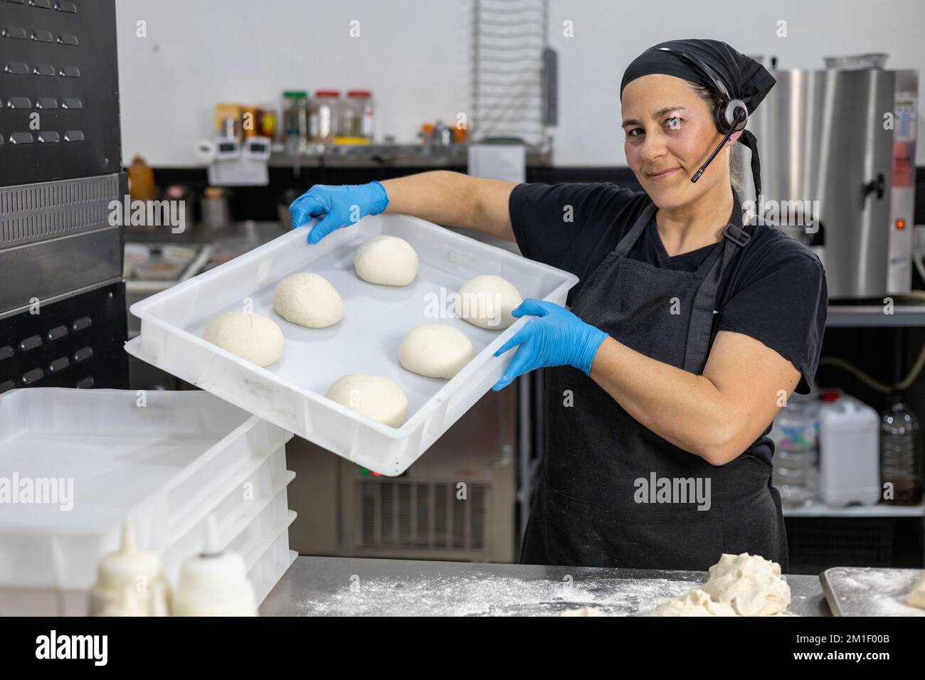 Professional Woman chef kneading bread dough Stock Photo - Alamy