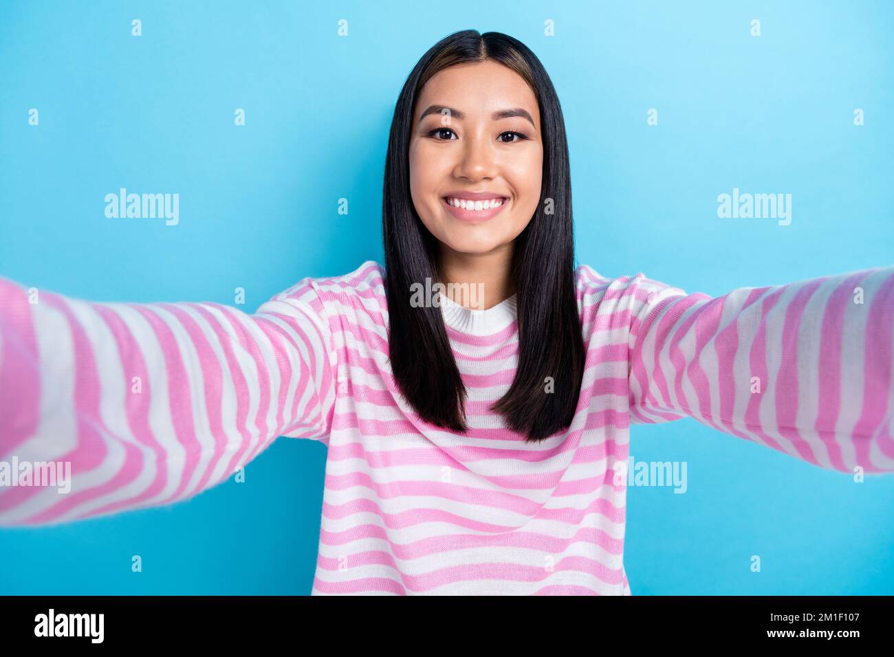Photo of cheerful cute girl dressed pink pullover smiling recording ...