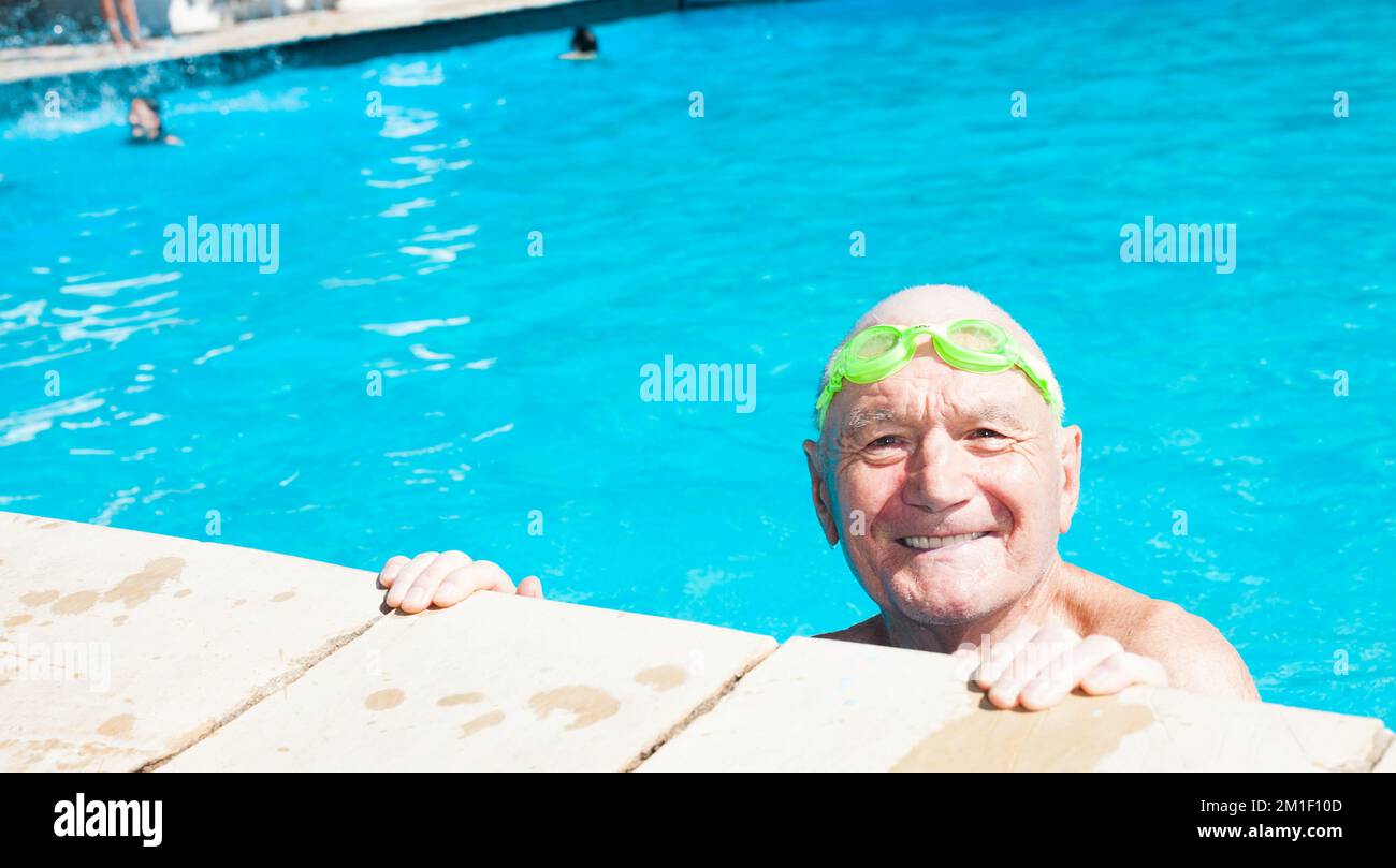happy old man posing in swimming pool Stock Photo - Alamy