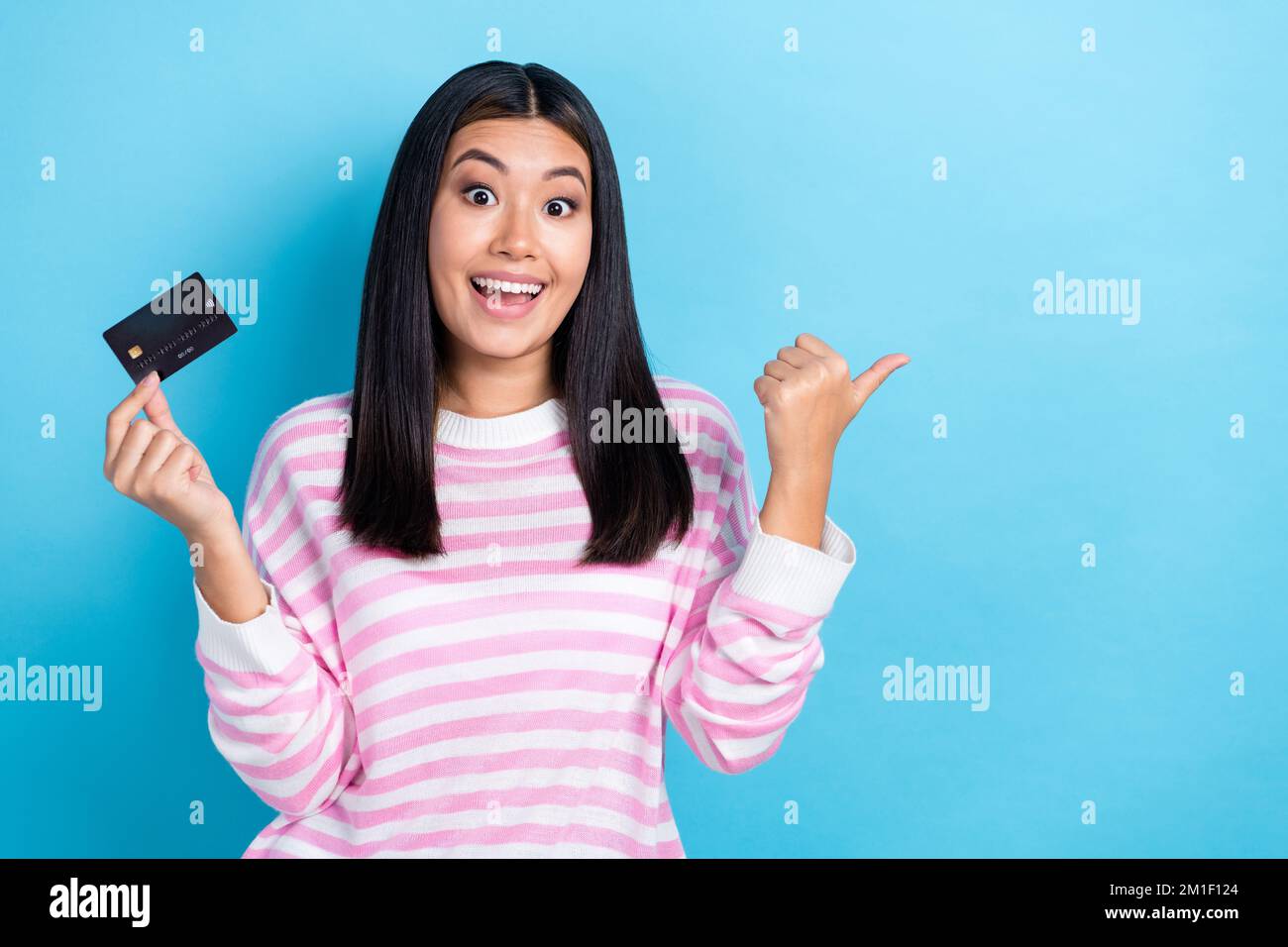 Photo of adorable excited girl dressed pink pullover pointing thumb ...