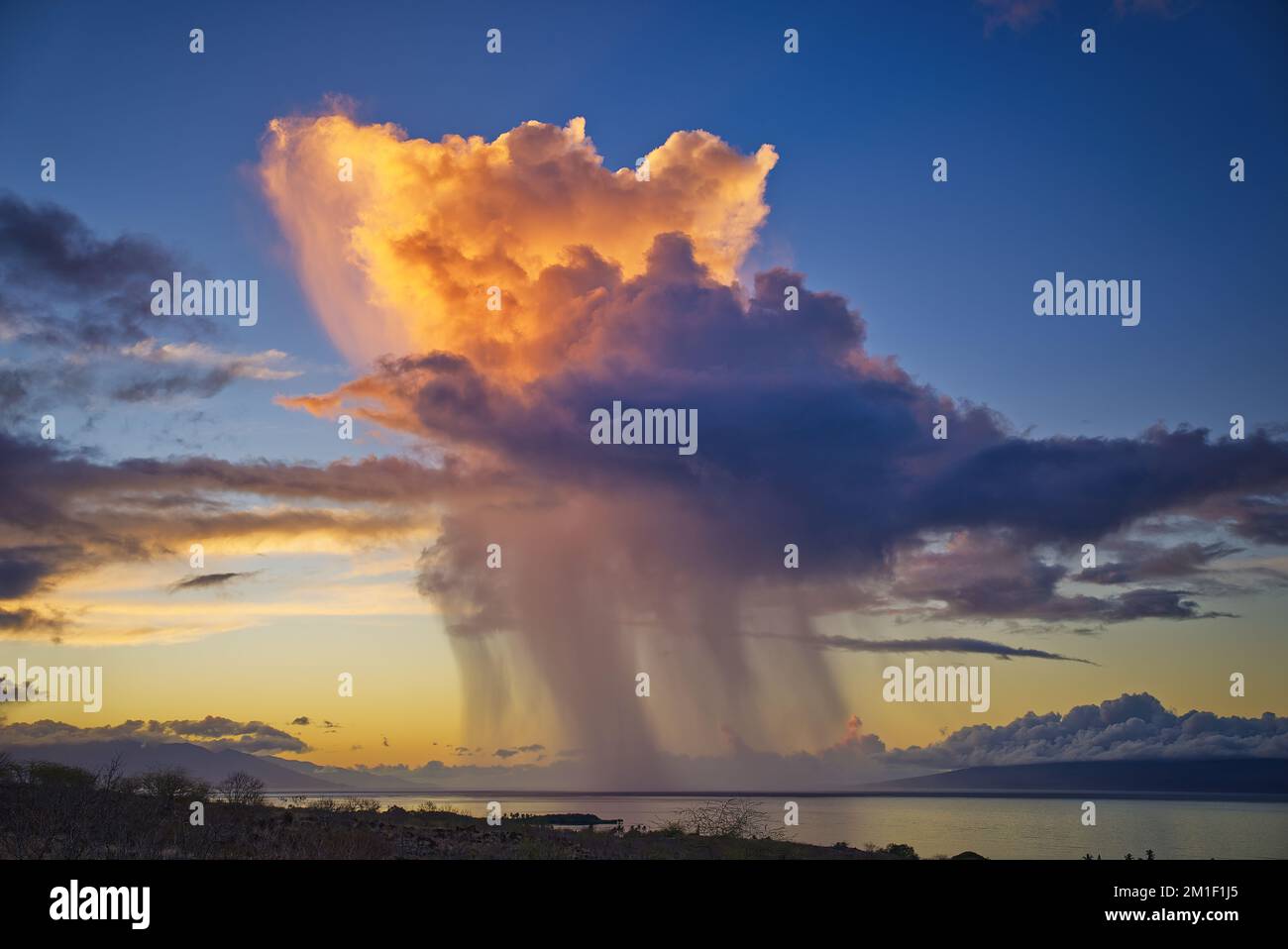 a rain cloud above Hawaii islands surrounded by highlands and clouds ...