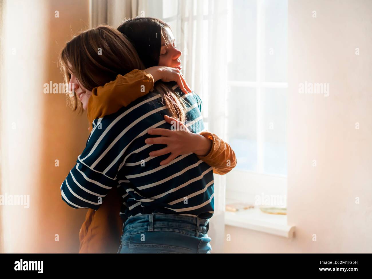 Two girls hug and congratulate each other Stock Photo - Alamy