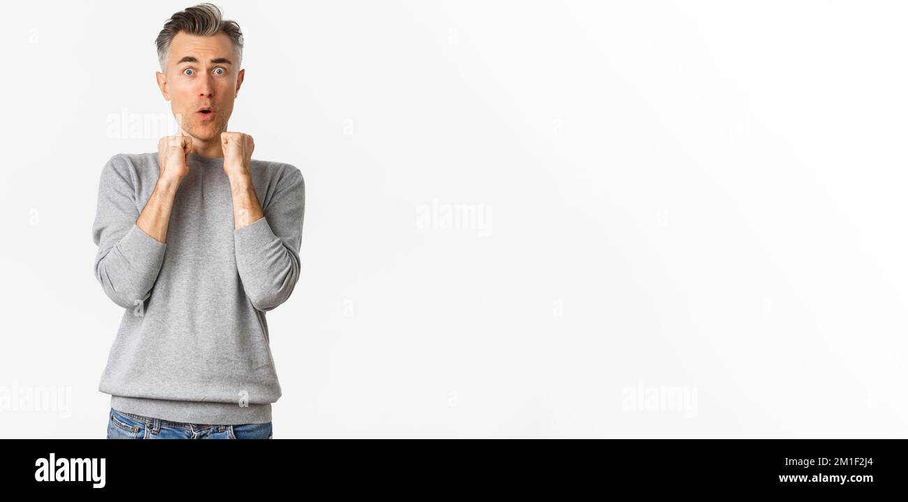 Image of scared middle-aged man with gray hair, jumping frightened and ...