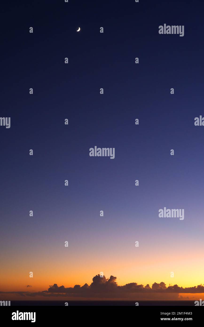 A vertical sunset sky gradient blue to orange, a Crescent moon, and ...