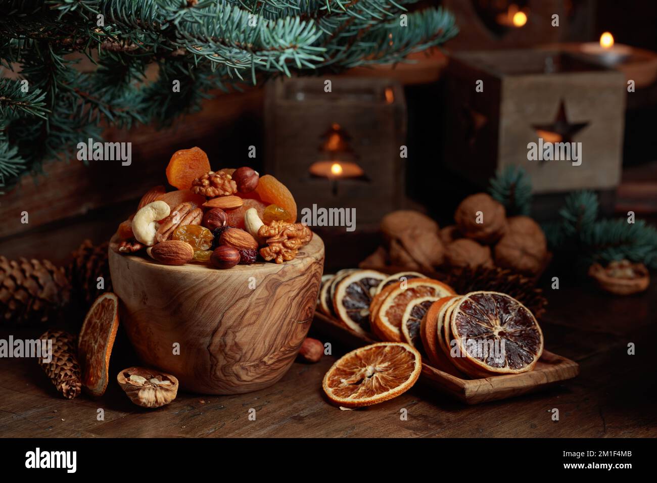 Dried fruits and assorted nuts on an old wooden table. Christmas still ...
