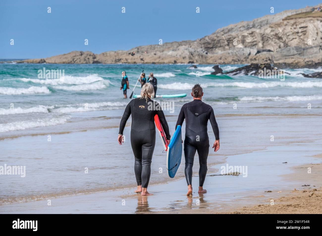 Body boarders carrying their body boards boogie boards walking along ...