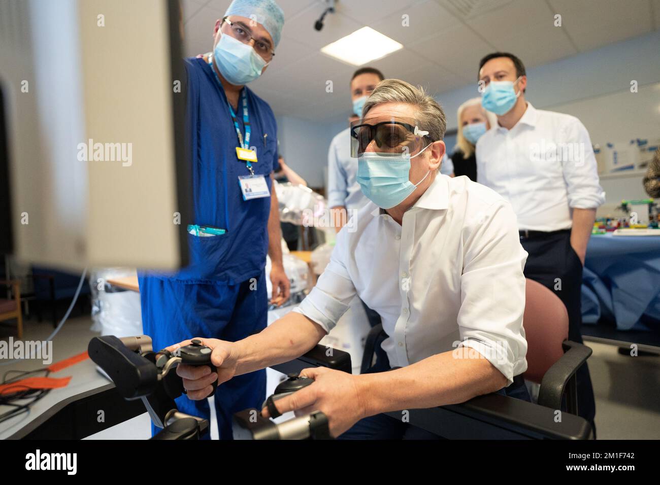 Labour Party leader Sir Keir Starmer (centre) tries his hand at ...