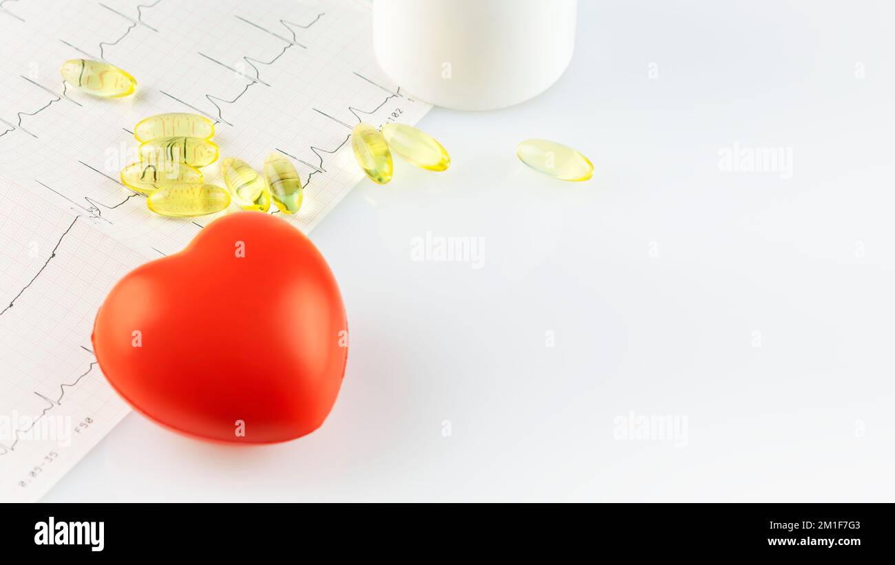 Vitamins and supplements for heart health. White bottle with healthy ...