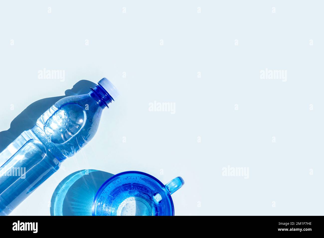 Bottled water. A bottle of mineral water and glass of water with hard ...