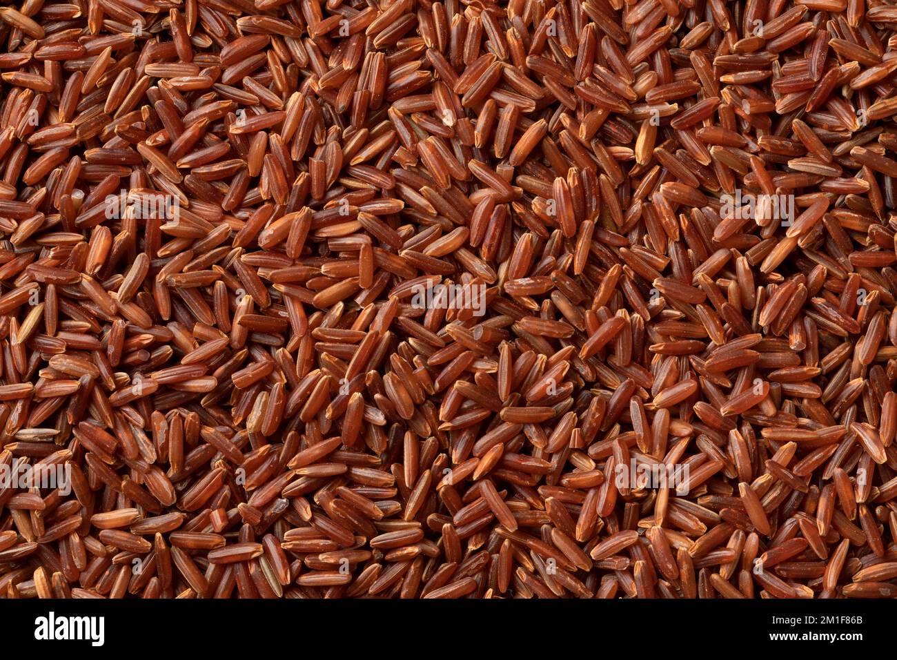 Organic red rice close up full frame as background Stock Photo - Alamy