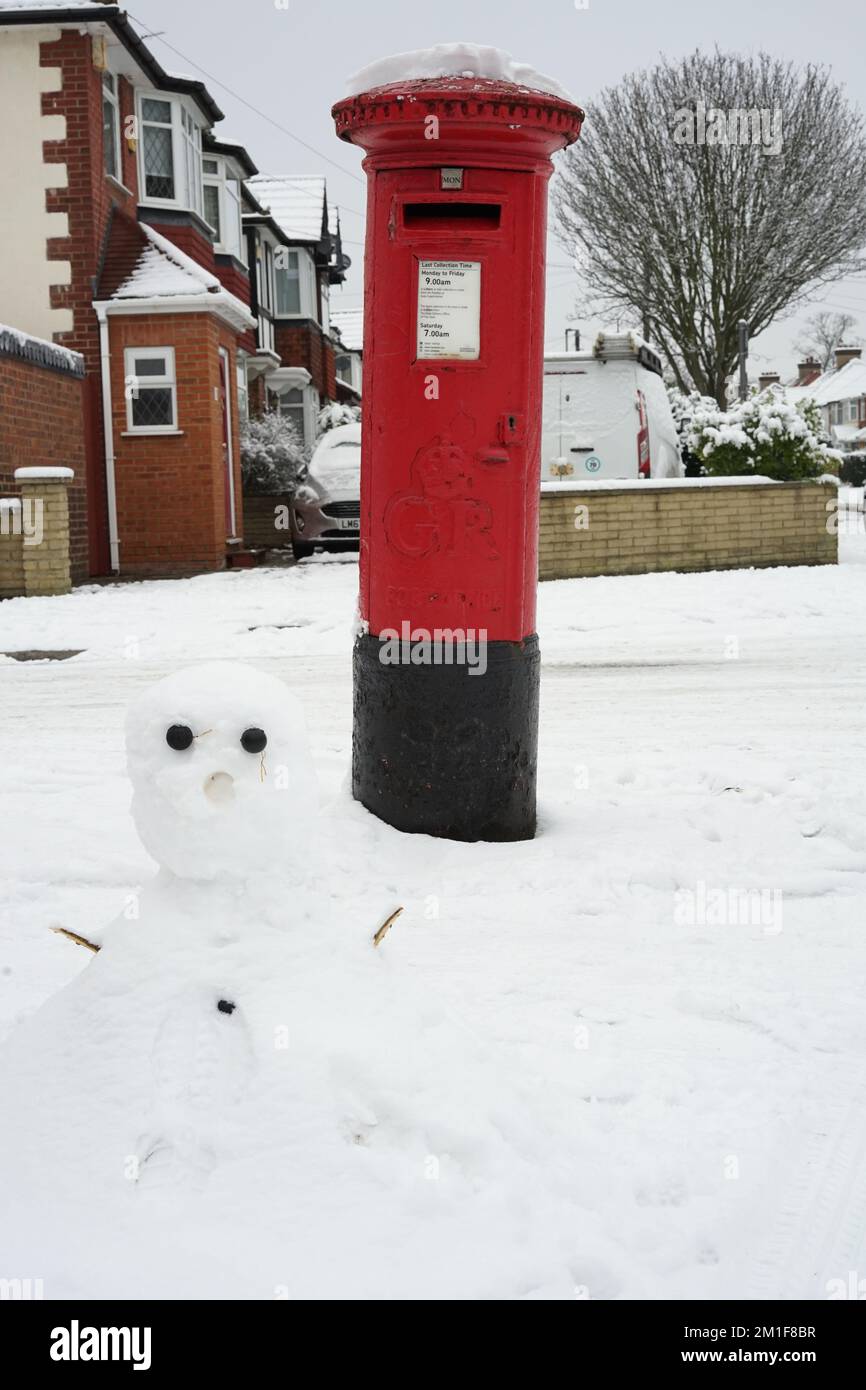 A Snow Man and post box on a snow-covered Greenway Gardens in Barnet ...