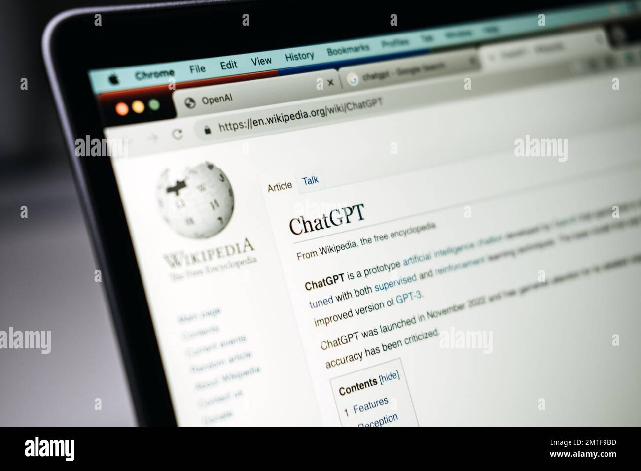 Screen with ChatGPT chat with AI or artificial intelligence. Man search for information using ...
