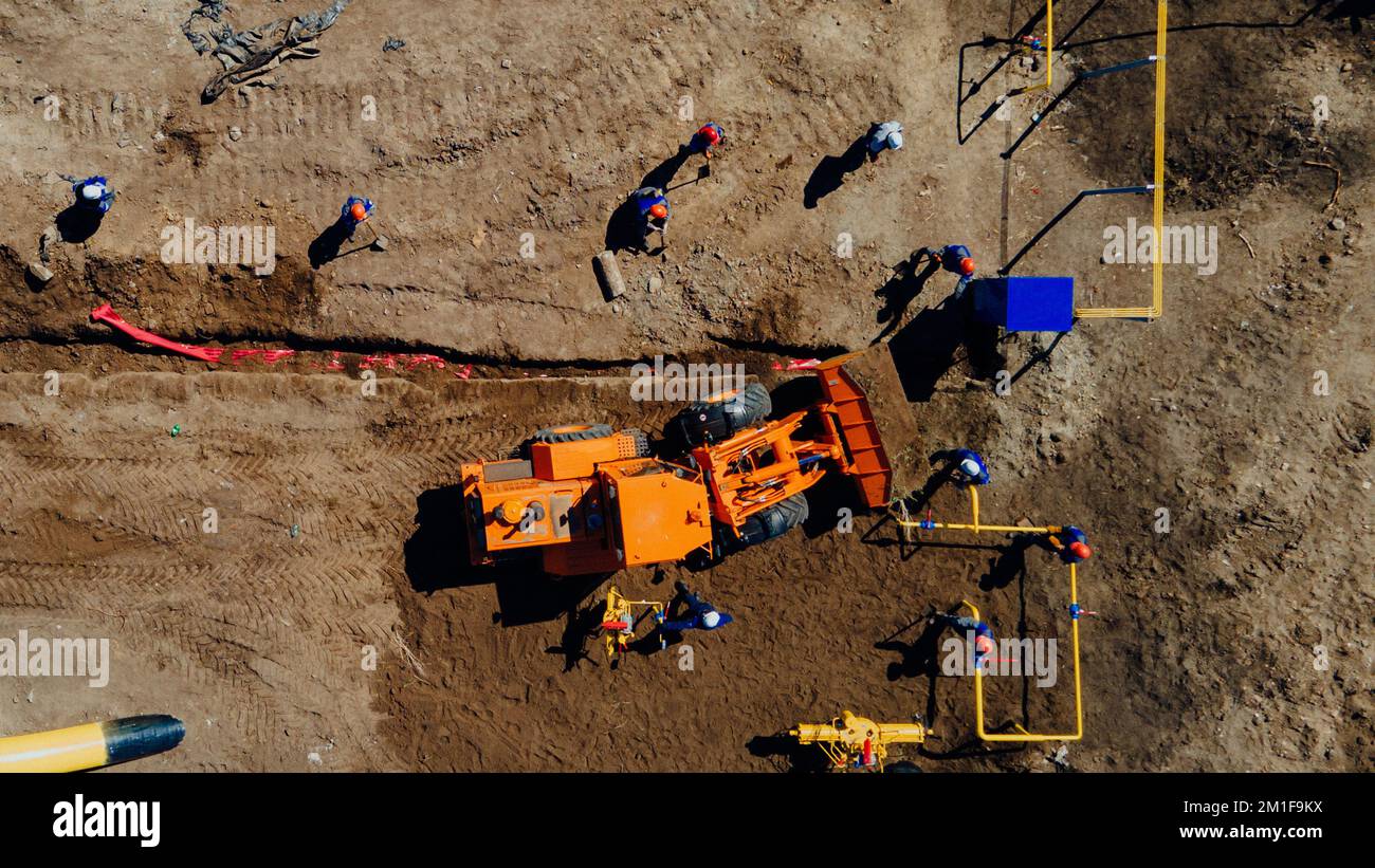 Aerial view excavator and construction workers working on construction ...