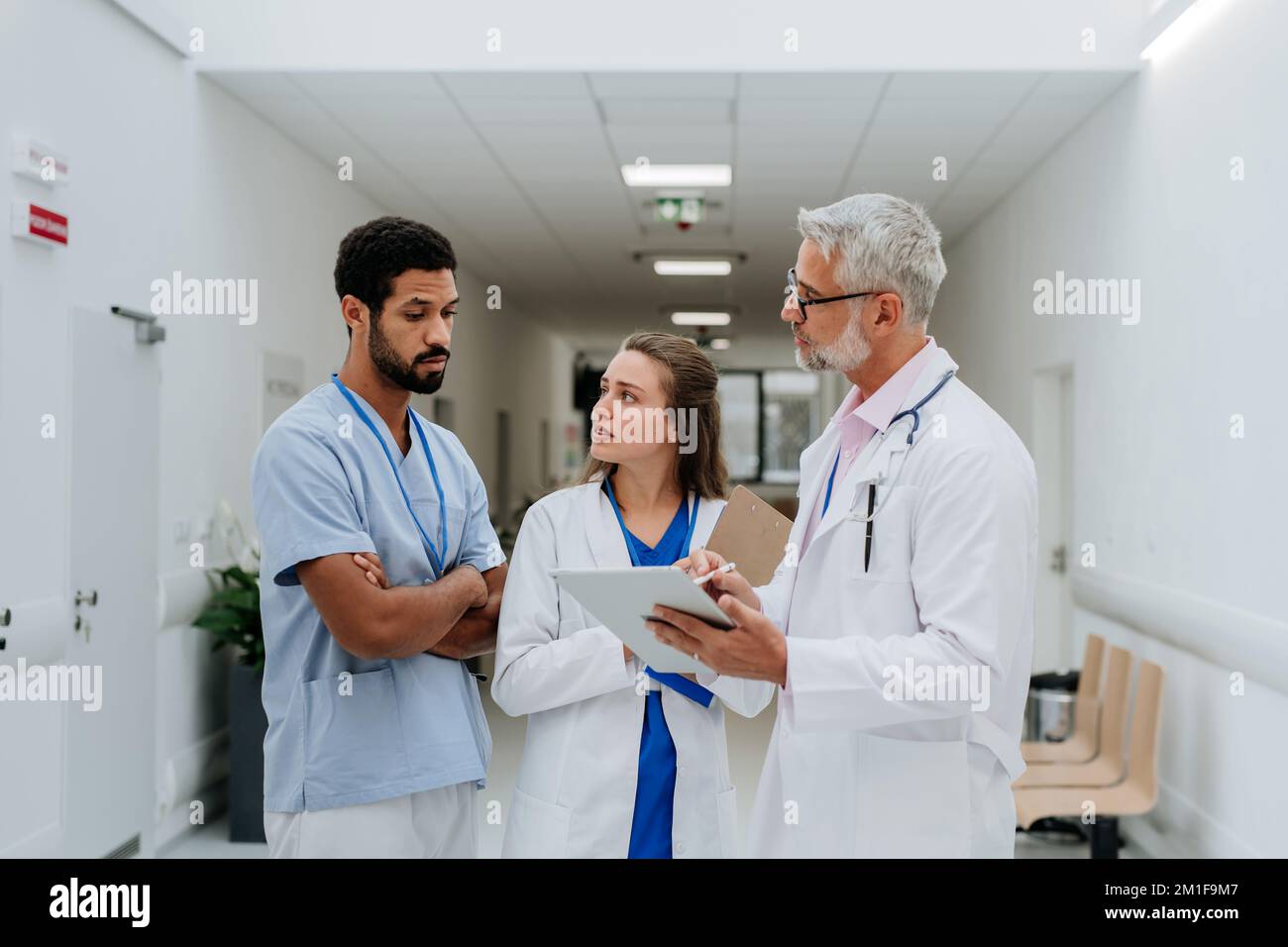 Team of doctors meeting at hospital corridor Stock Photo - Alamy