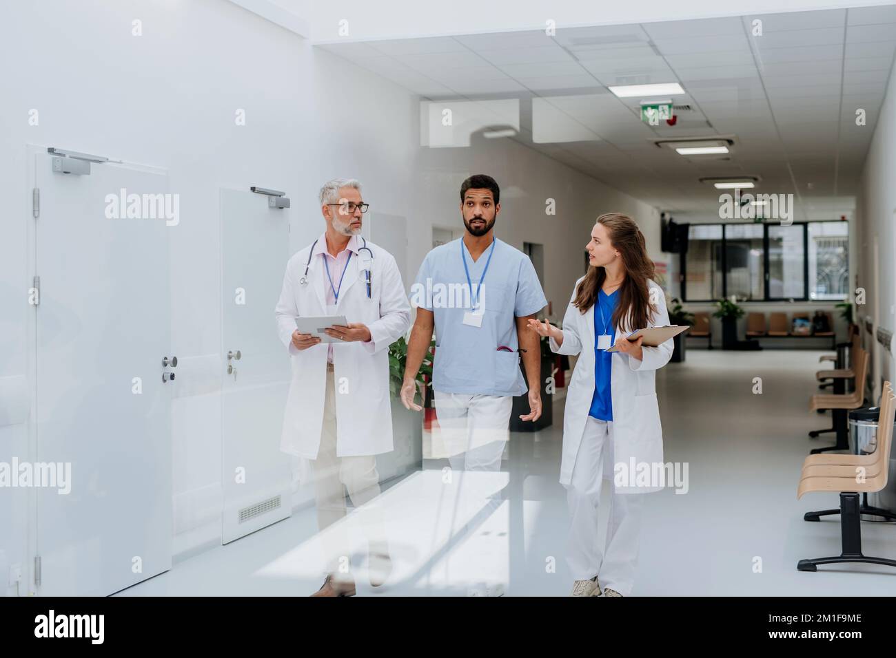 Team of doctors meeting at hospital corridor Stock Photo - Alamy