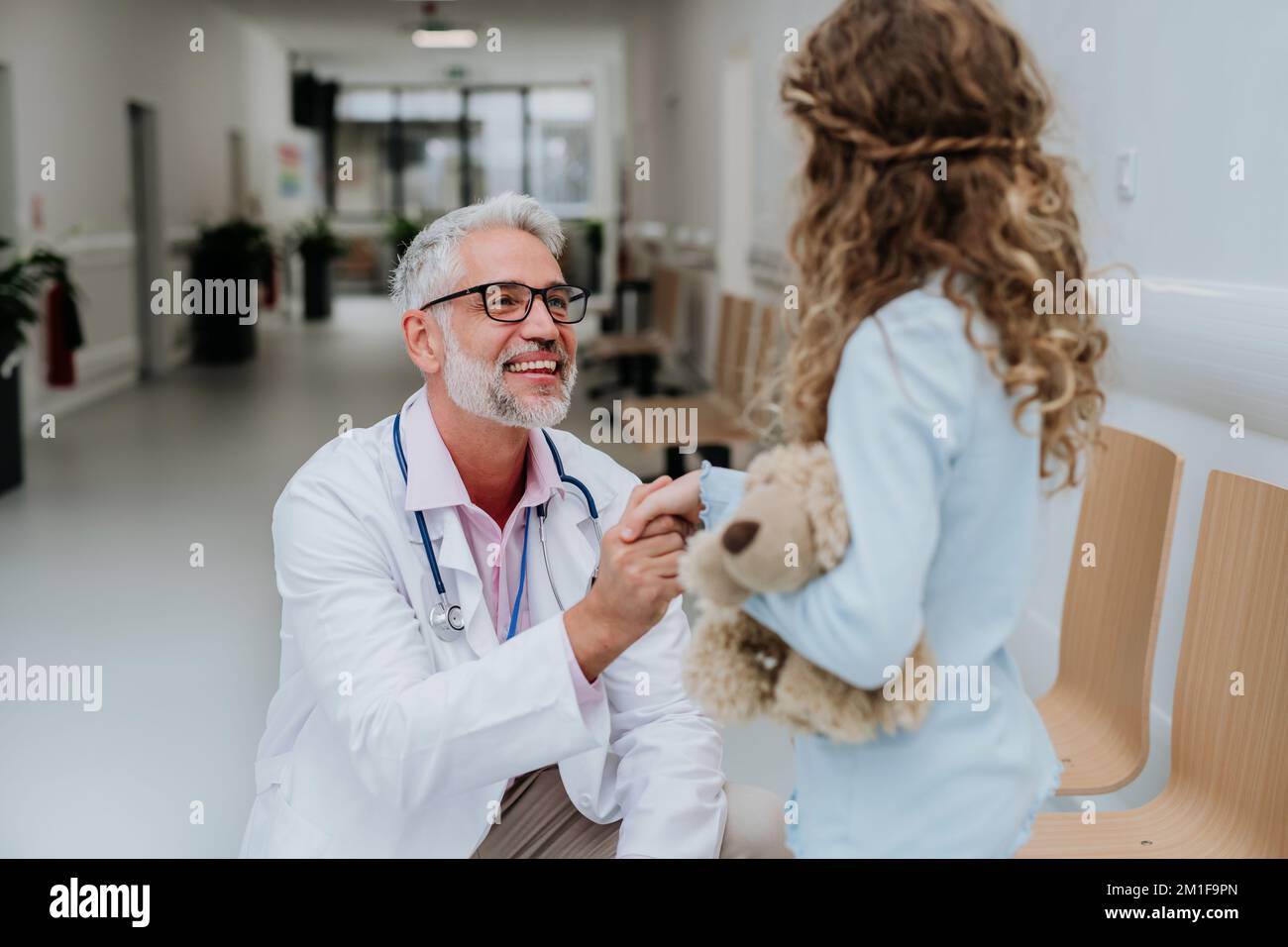 Doctor playing with his little patient at pediatrics Stock Photo - Alamy