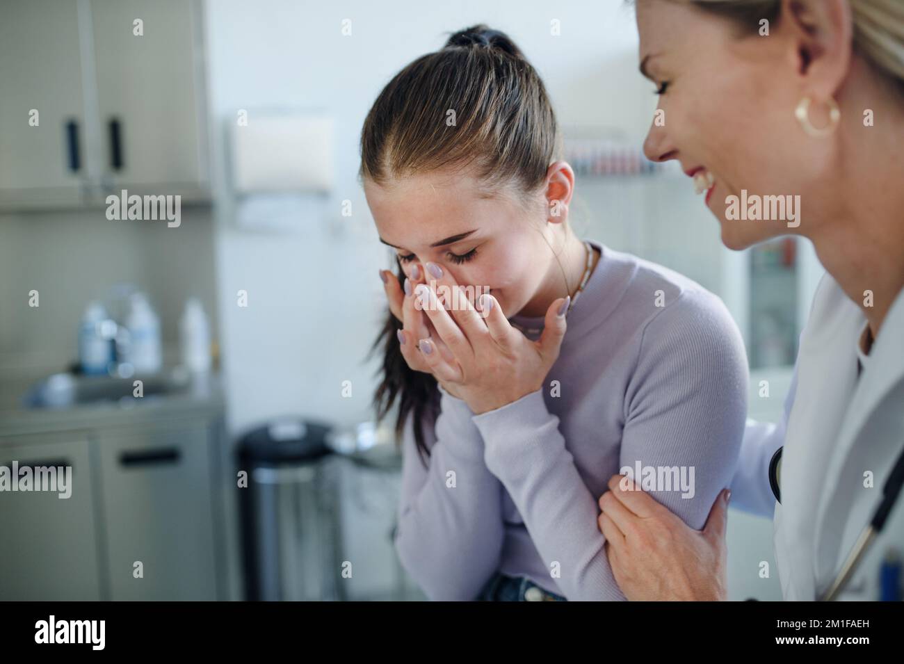 Young woman doctor laughing with teenage girl in her ambulance Stock ...