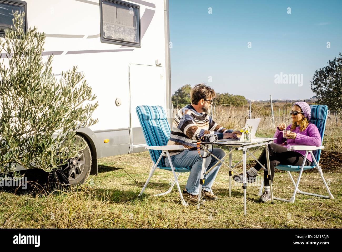 Happy tourist couple enjoy outdoor leisure activity sitting on the ...